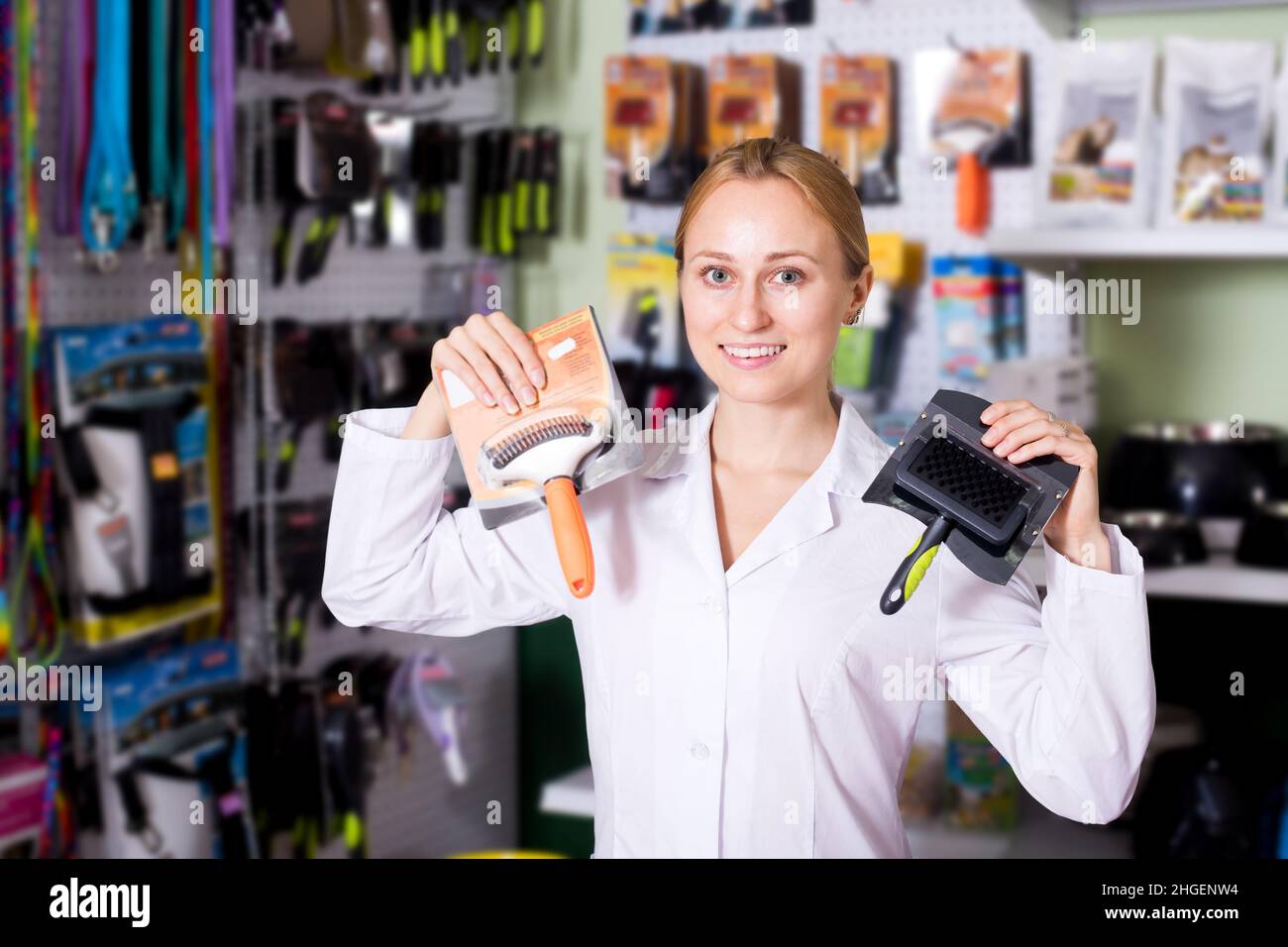 Shop assistant offers to choose grooming brushes Stock Photo - Alamy
