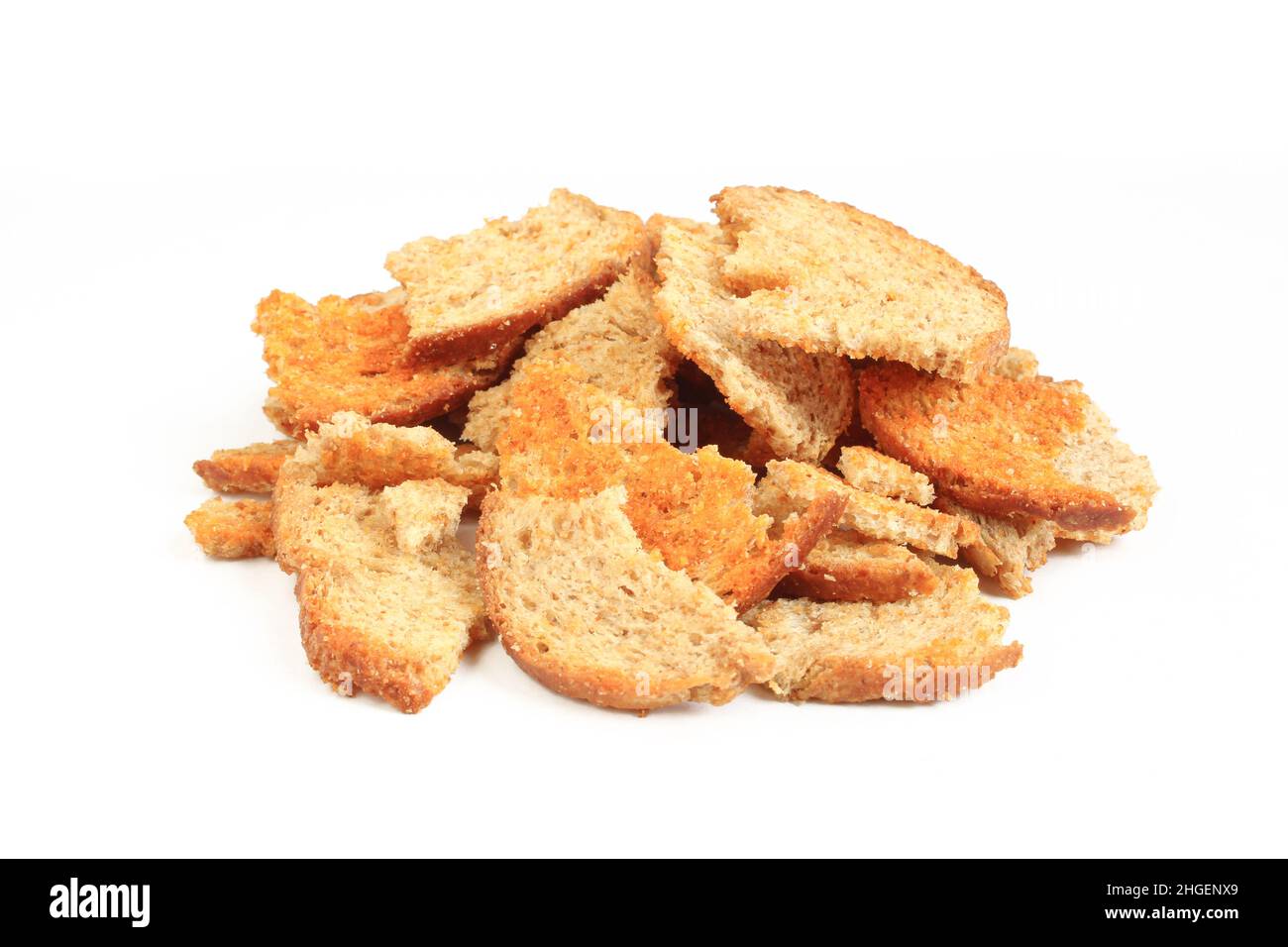 Toasted bread pieces isolated on white background. Pile of flavored ...