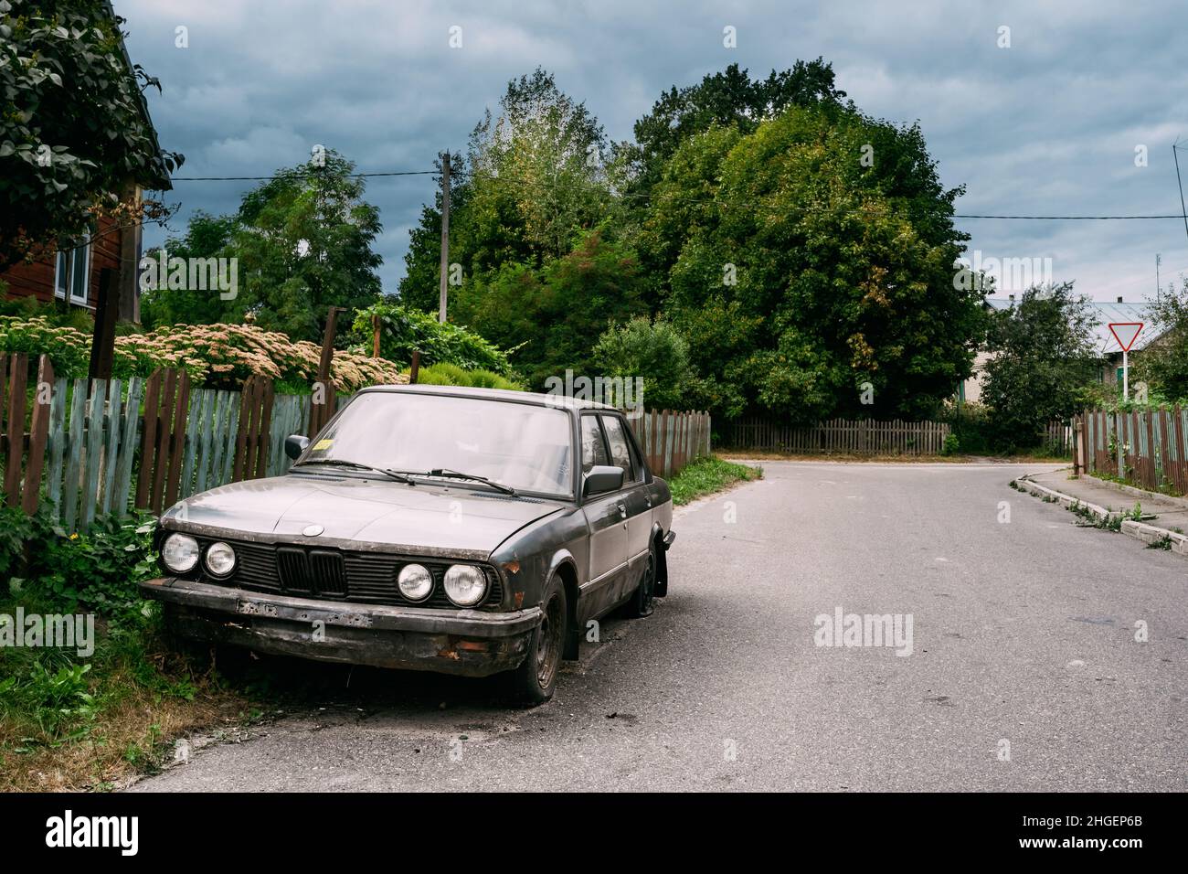 Old rusty sedan car BMW 3 Series (E30) parking on street. The BMW E30 ...