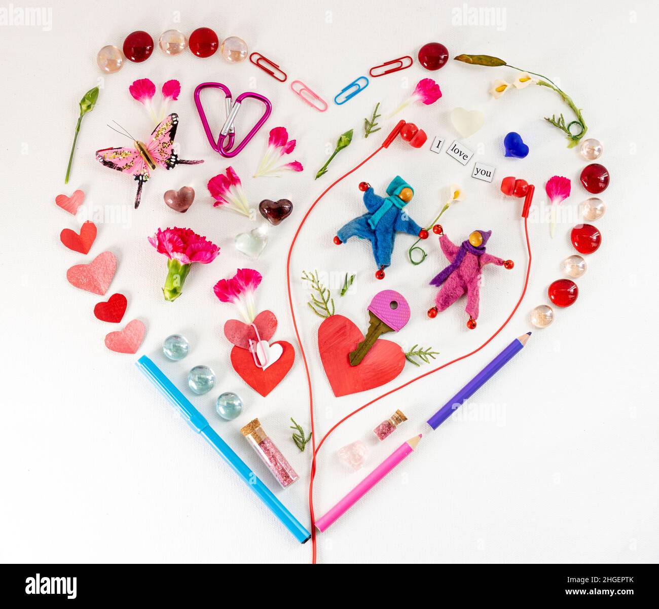 Heart shape lat design using office and art supplies, petals, butterfly ...