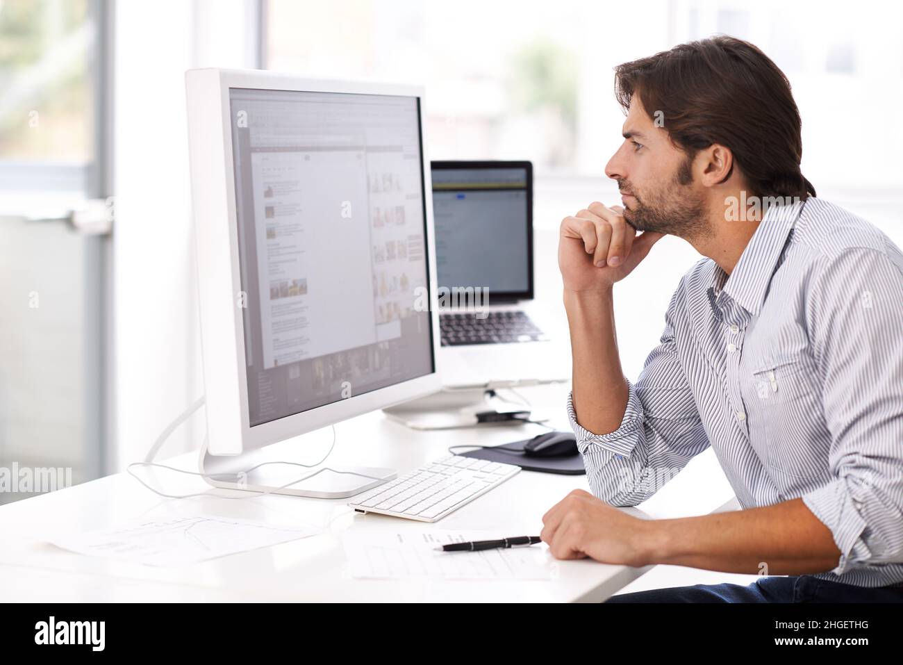 Turning his ideas into reality. Shot of a handsome man working on a ...