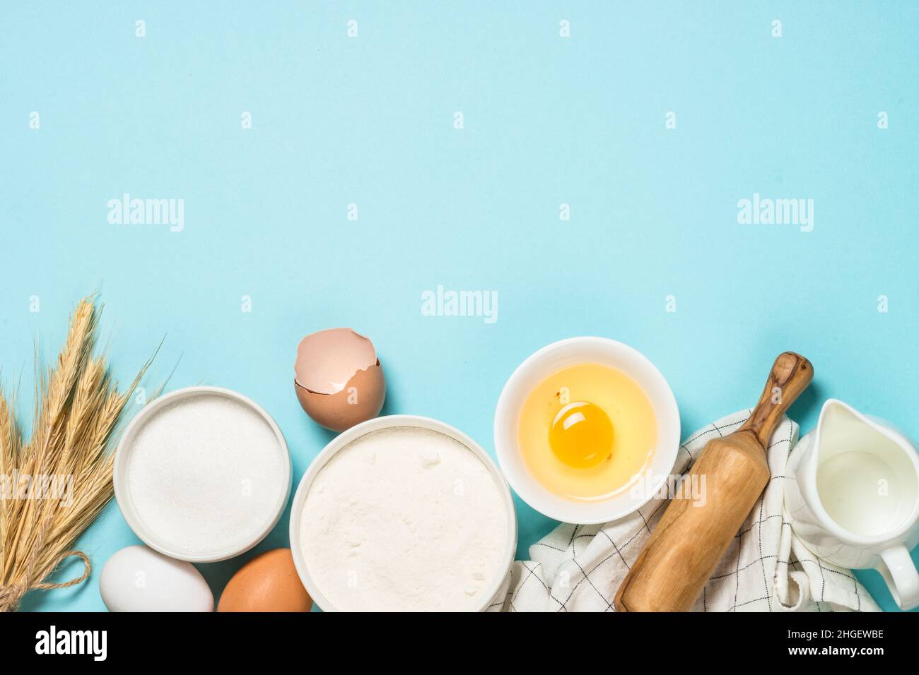 Baking ingredients at blue table top view Stock Photo - Alamy