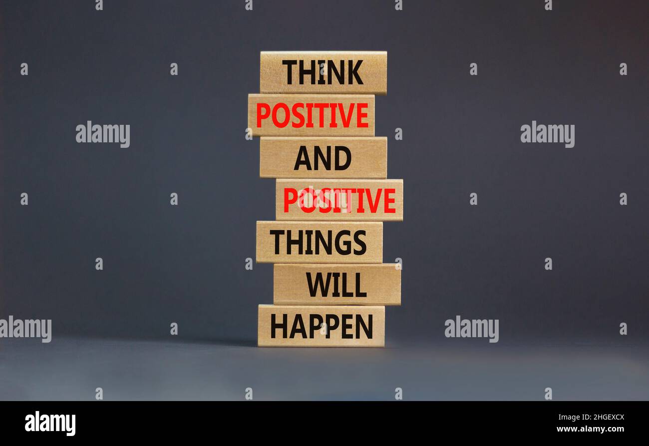 Think positive symbol. Wooden blocks with words Think positive and ...