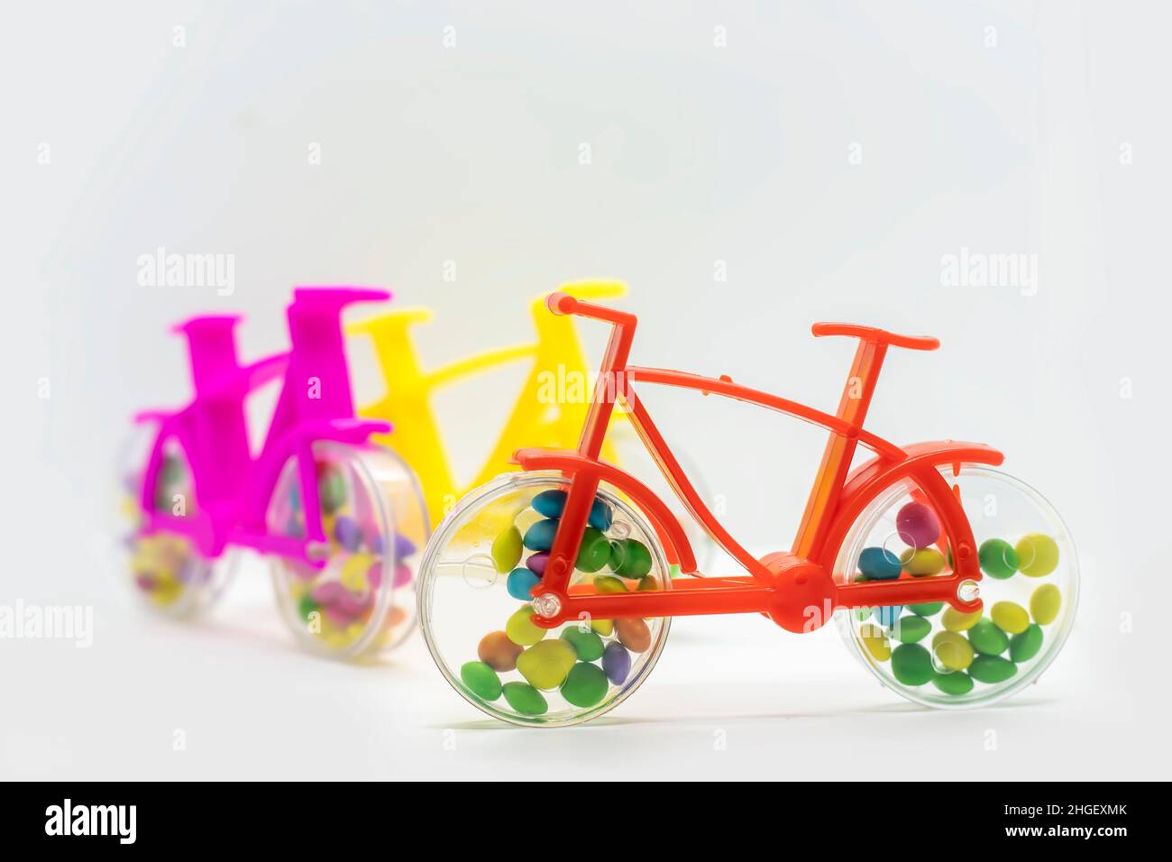 Plastic toy bicycle with chocolate nut candy inside the bicycle wheel ...