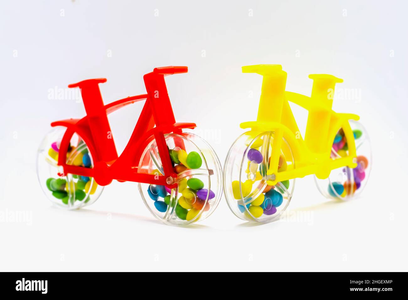 Red and yellow plastic bicycle toy in white background Stock Photo - Alamy