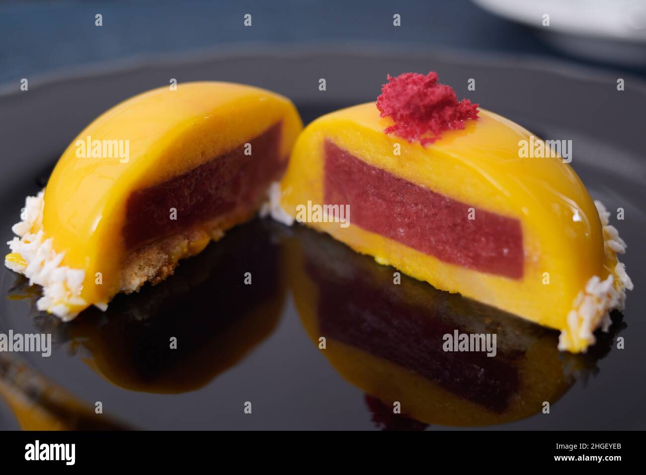 Incredibly beautiful yellow dessert on a black plate and black ...