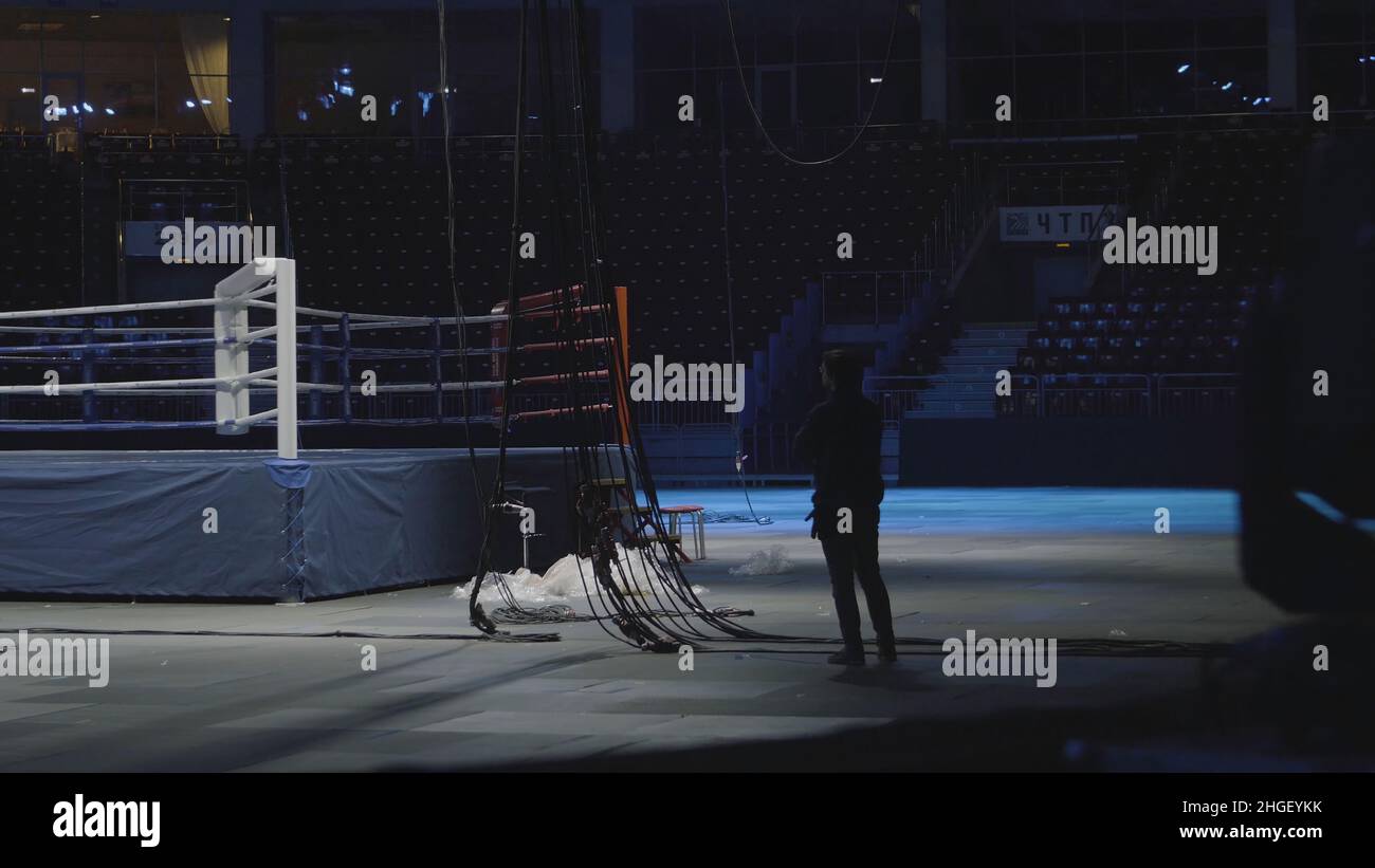 A dramatic view of the red corner of a regular boxing ring surrounded ...