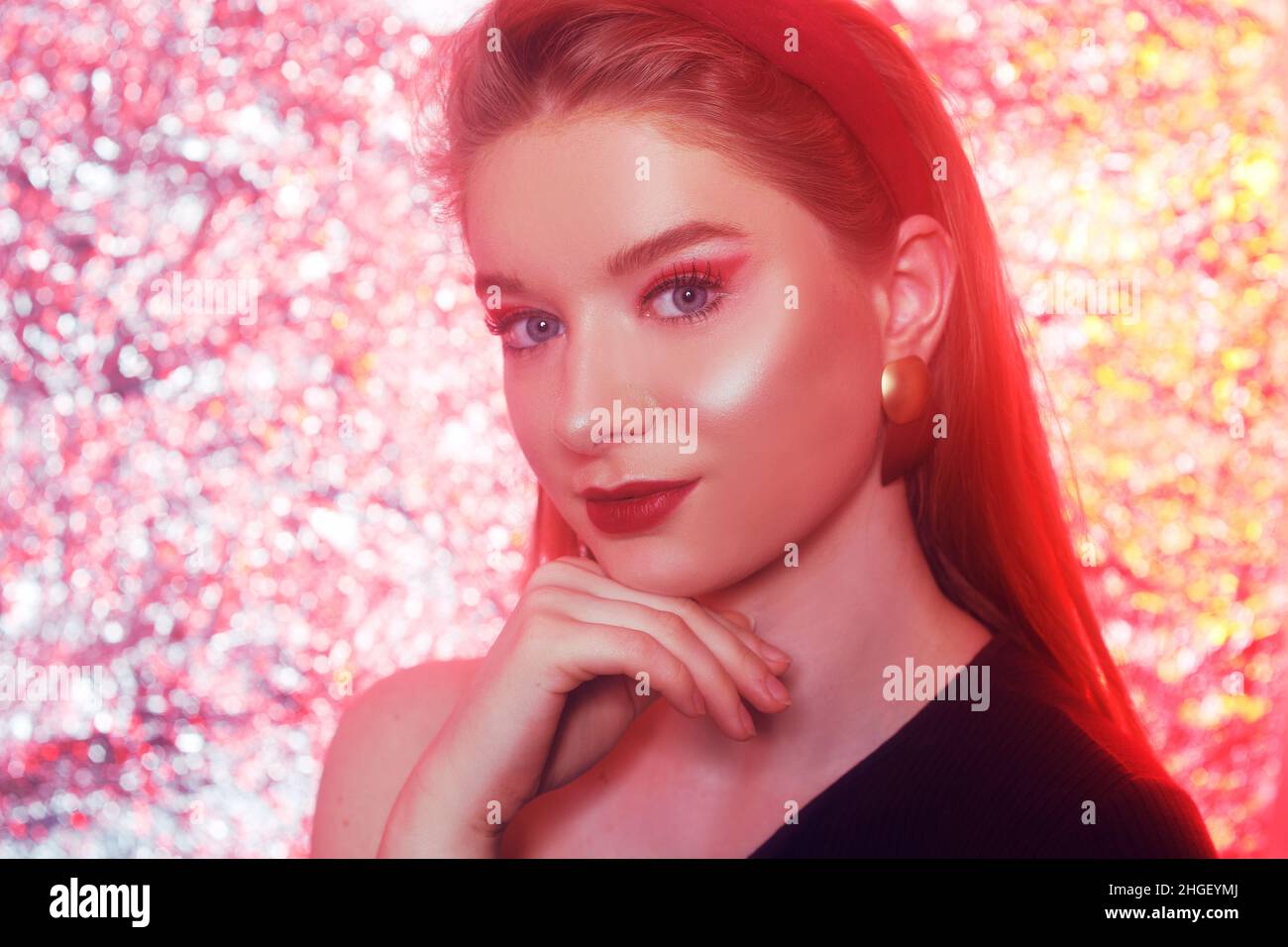 Gorgeous blonde on a bright bokeh background. Girl with pink makeup, in ...