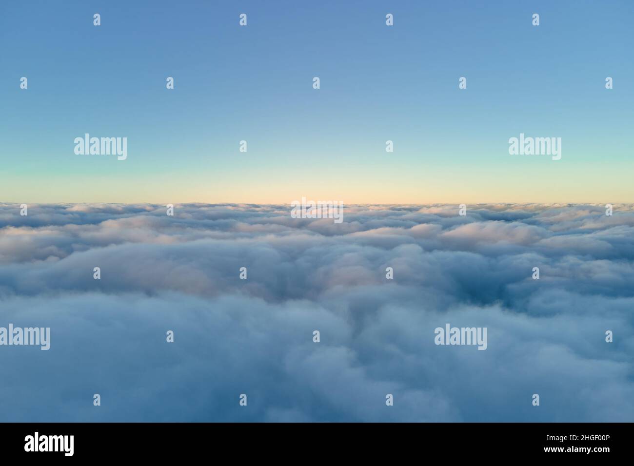 Aerial view from airplane window at high altitude of dense puffy ...