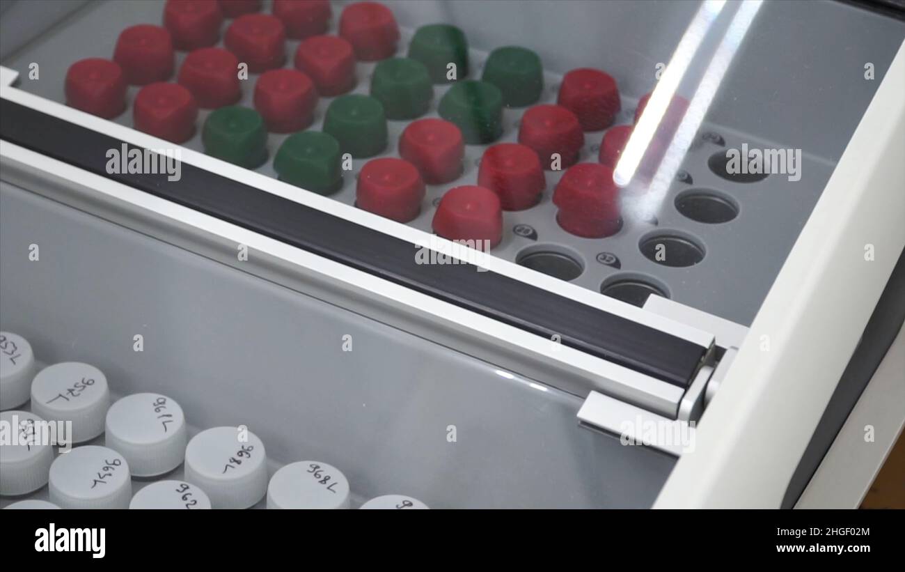 Test tubes and bottles arranged on medical trolley. Rack of test tubes ...
