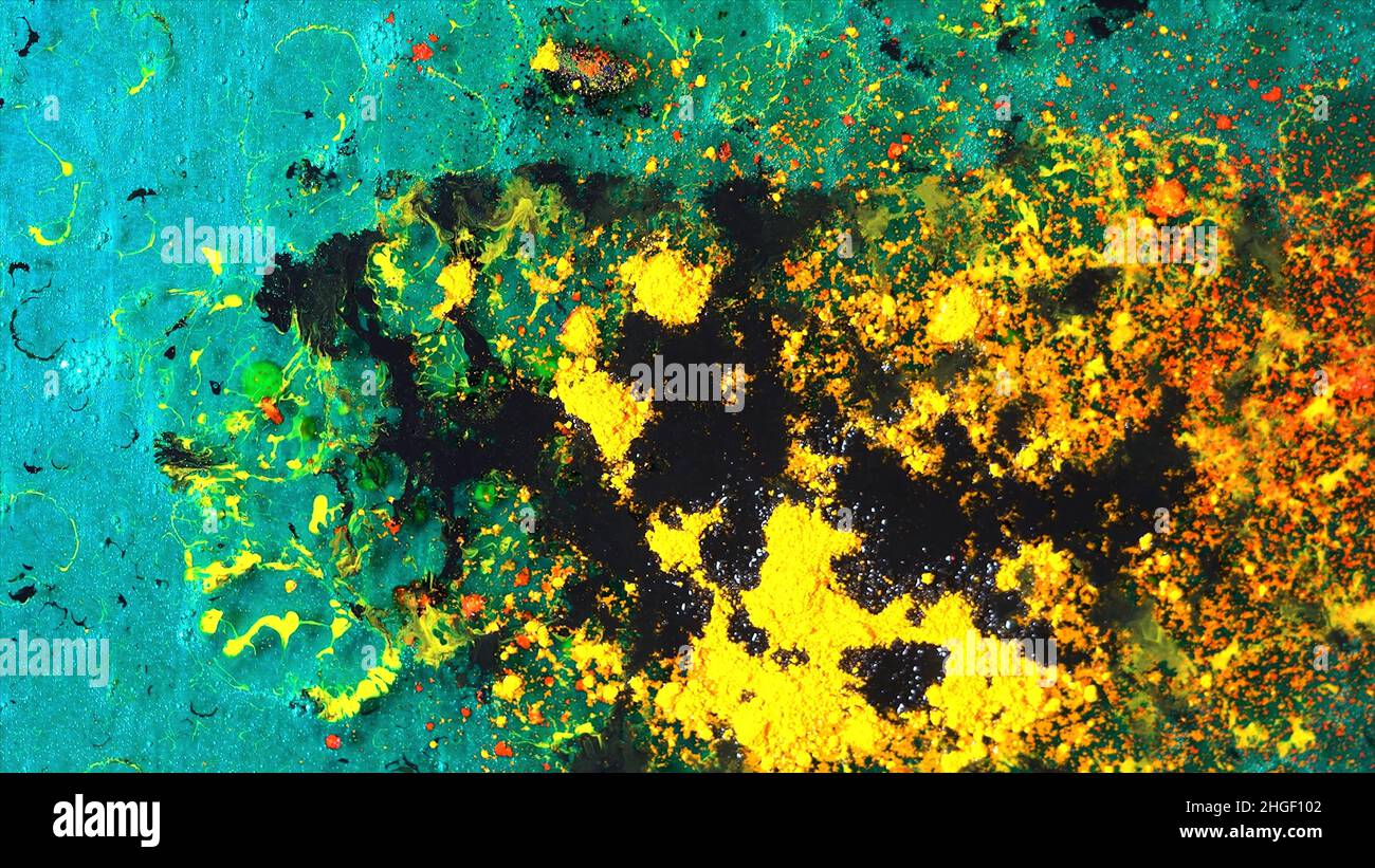 Top view of yellow dry inks getting soaked by black liquid pain on ...