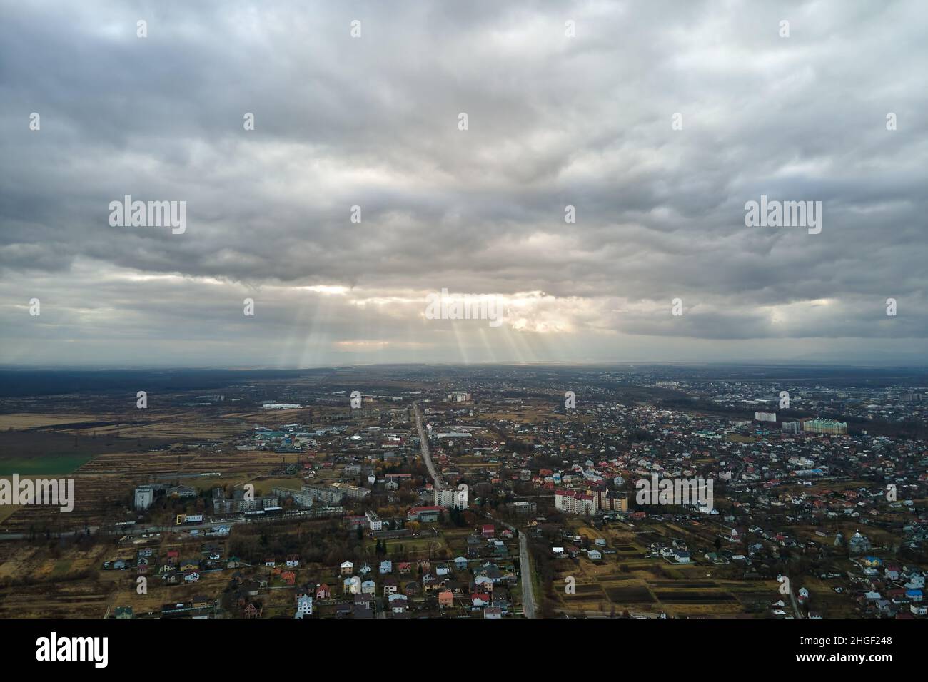 Aerial view of rural homes and distant high rise apartment buildings in ...