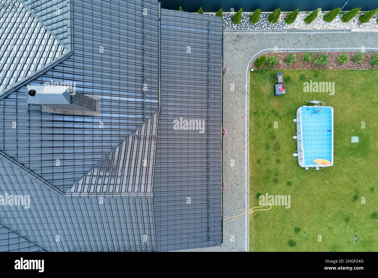 Aerial view of private house with green backyard and small swimming ...