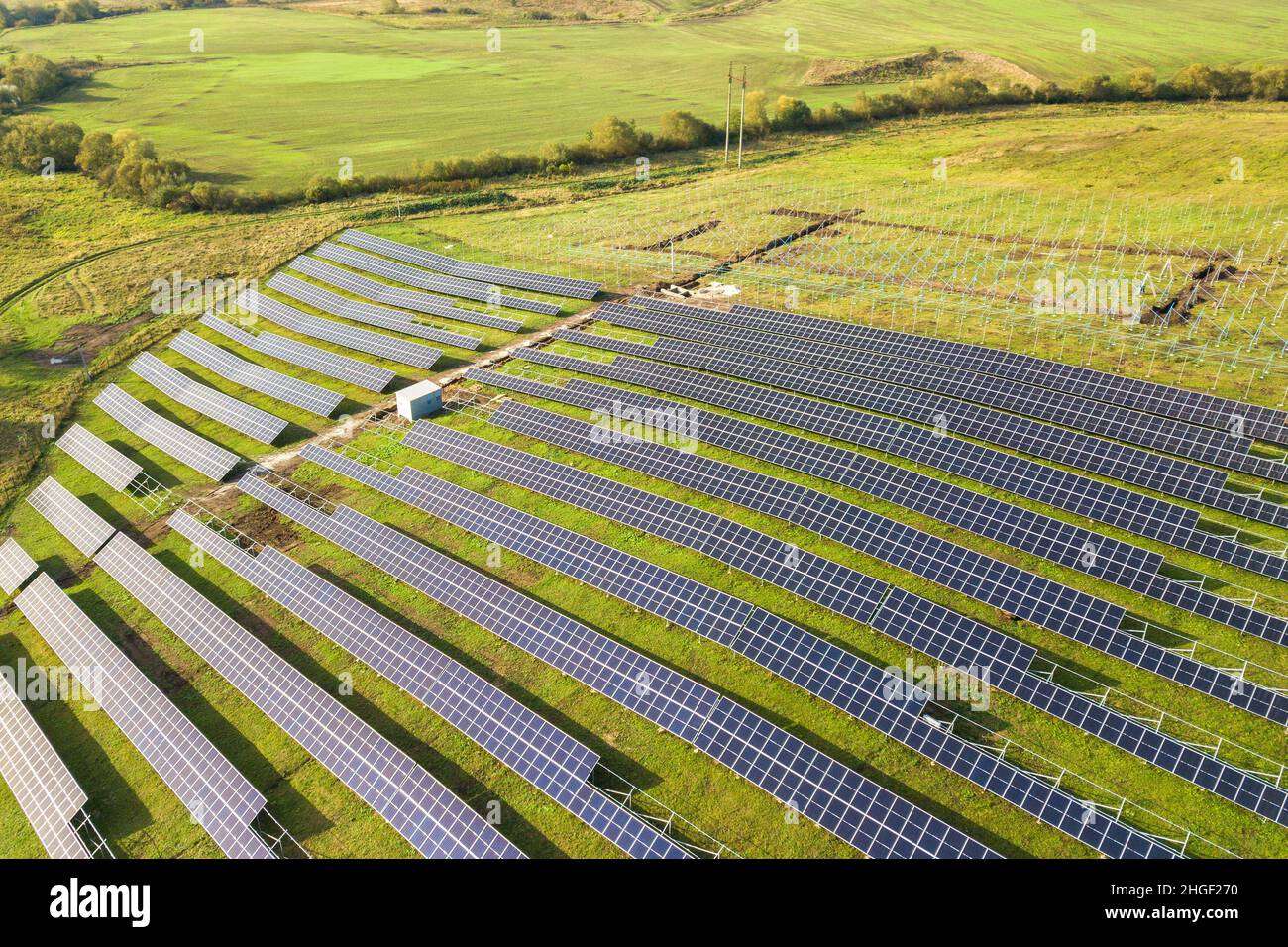 Aerial view of solar power plant under construction on green field ...