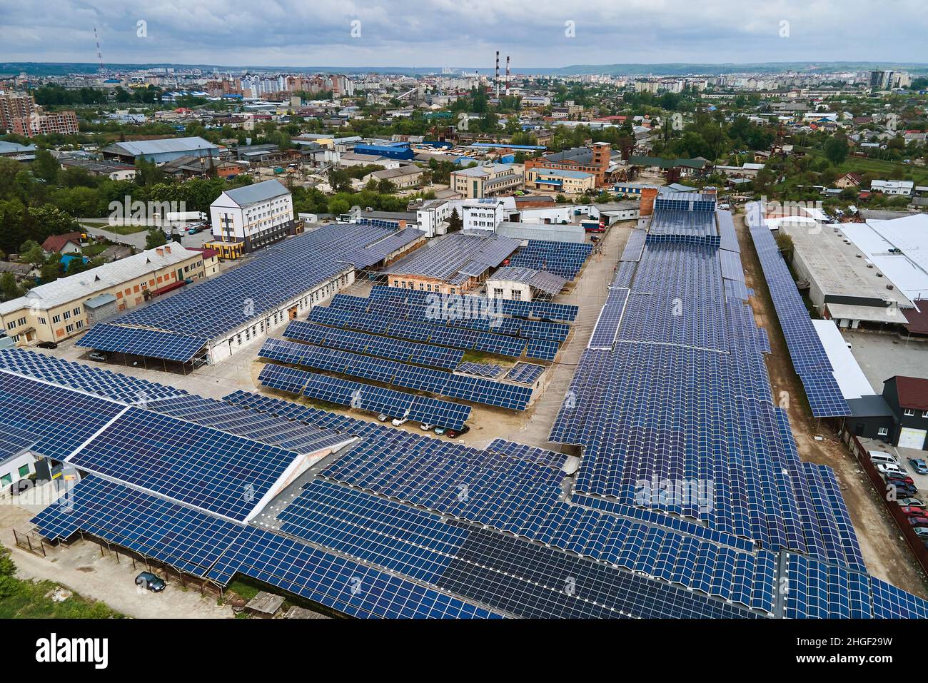 Aerial view of solar power plant with blue photovoltaic panels mounted ...