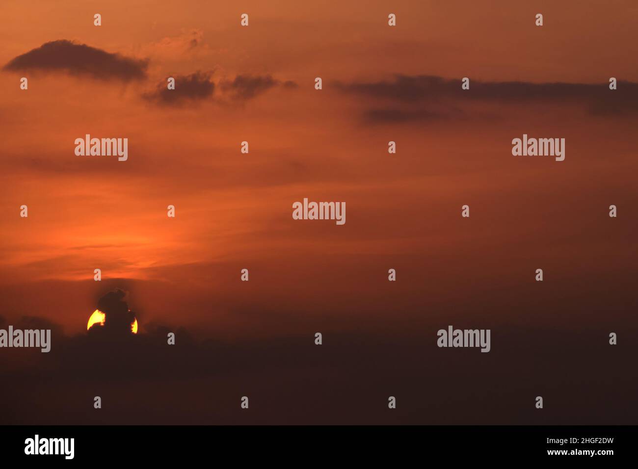 Bright colorful sunset sky with rays of setting sun and vivid dark ...