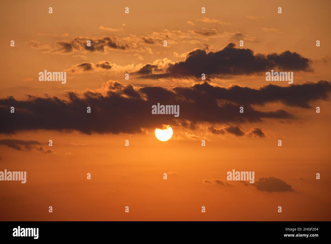 Bright colorful sunset sky with rays of setting sun and vivid dark ...
