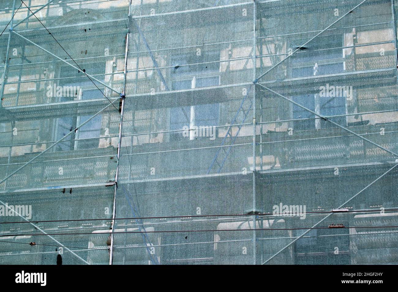 Building facade under renovation works with construction scaffolding ...