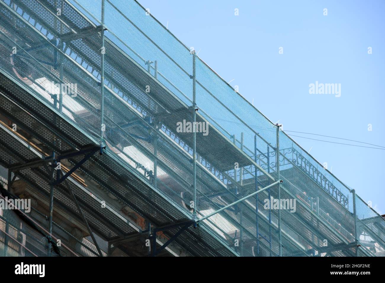 Building facade under renovation works with construction scaffolding ...