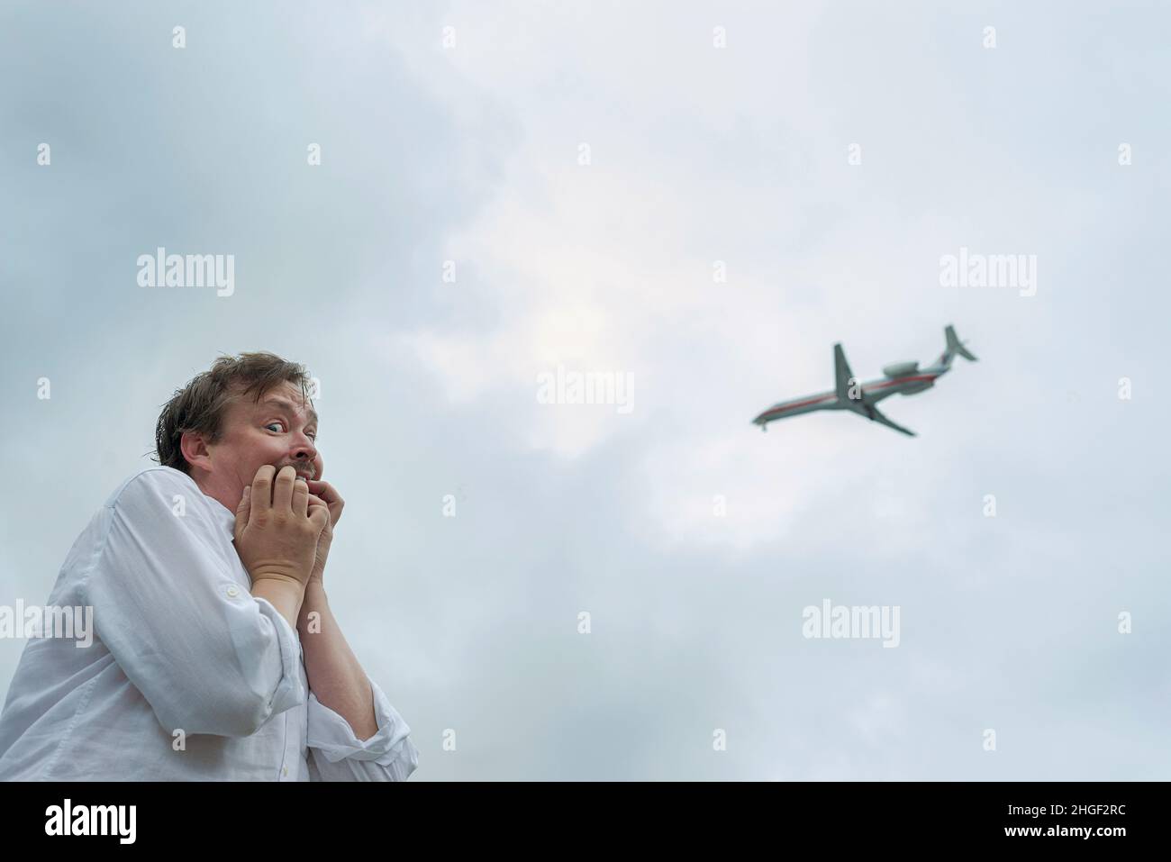A person exhibiting signs of fear of flying Stock Photo - Alamy