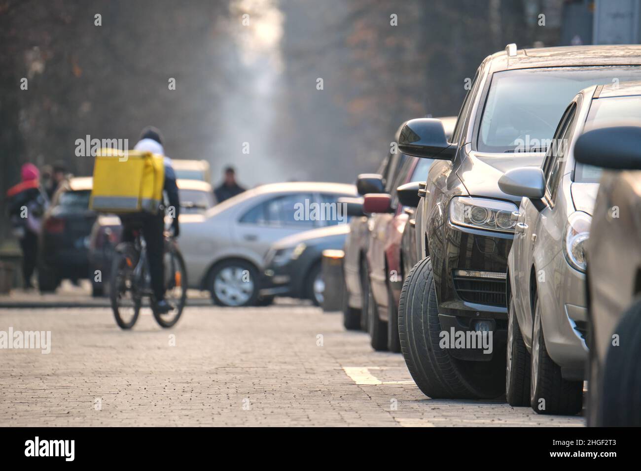 City traffic with cars parked in line on street side Stock Photo - Alamy