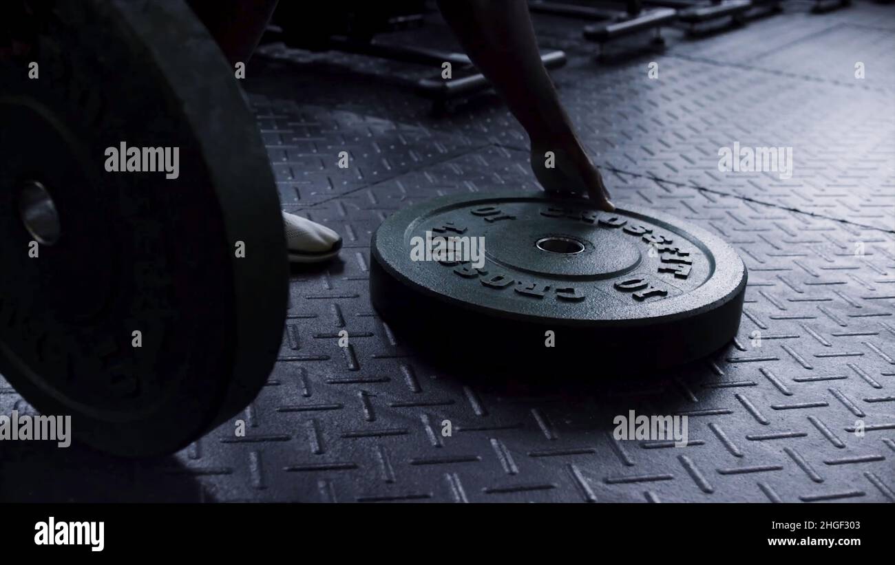 Close up for heavy weight plates on the gym floor ready to be used by a ...