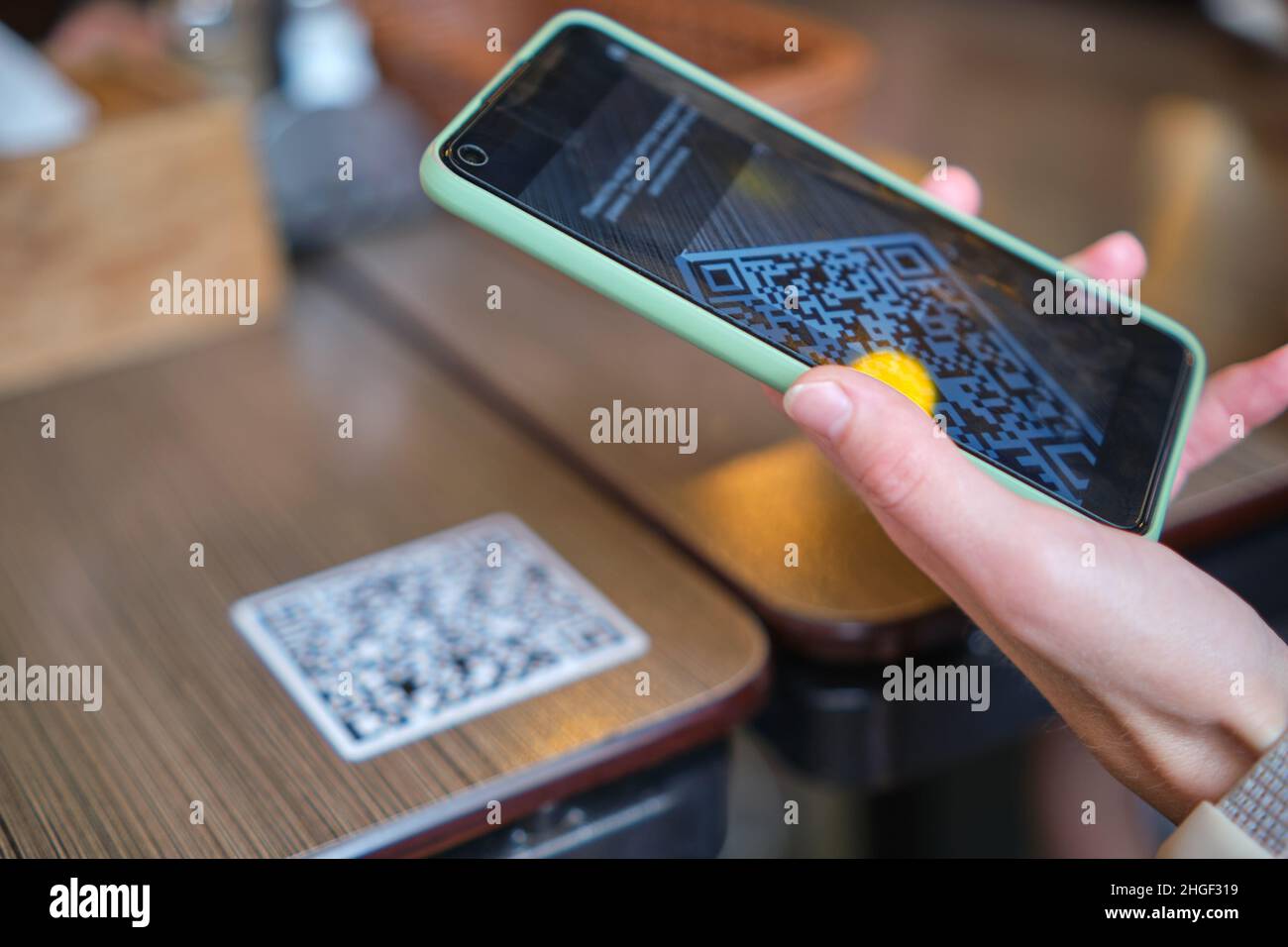 Closeup of guest hand ordering meal in restaurant while scanning qr ...