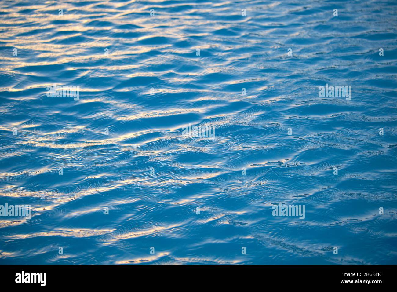 Closeup seascape surface of blue sea water with small ripple waves ...