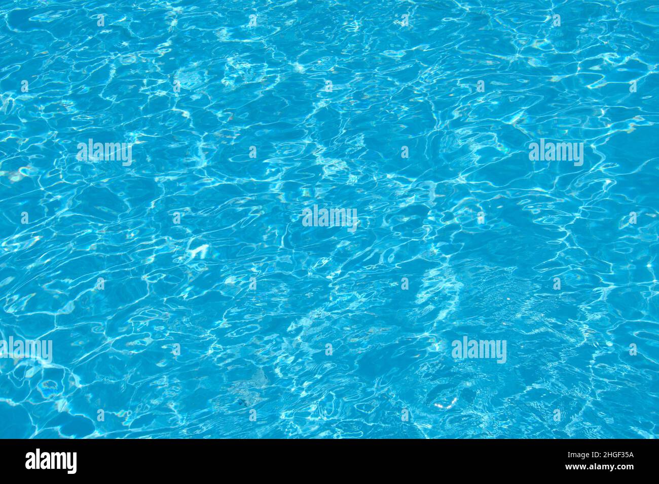 Closeup surface of blue clear water with small ripple waves in swimming ...