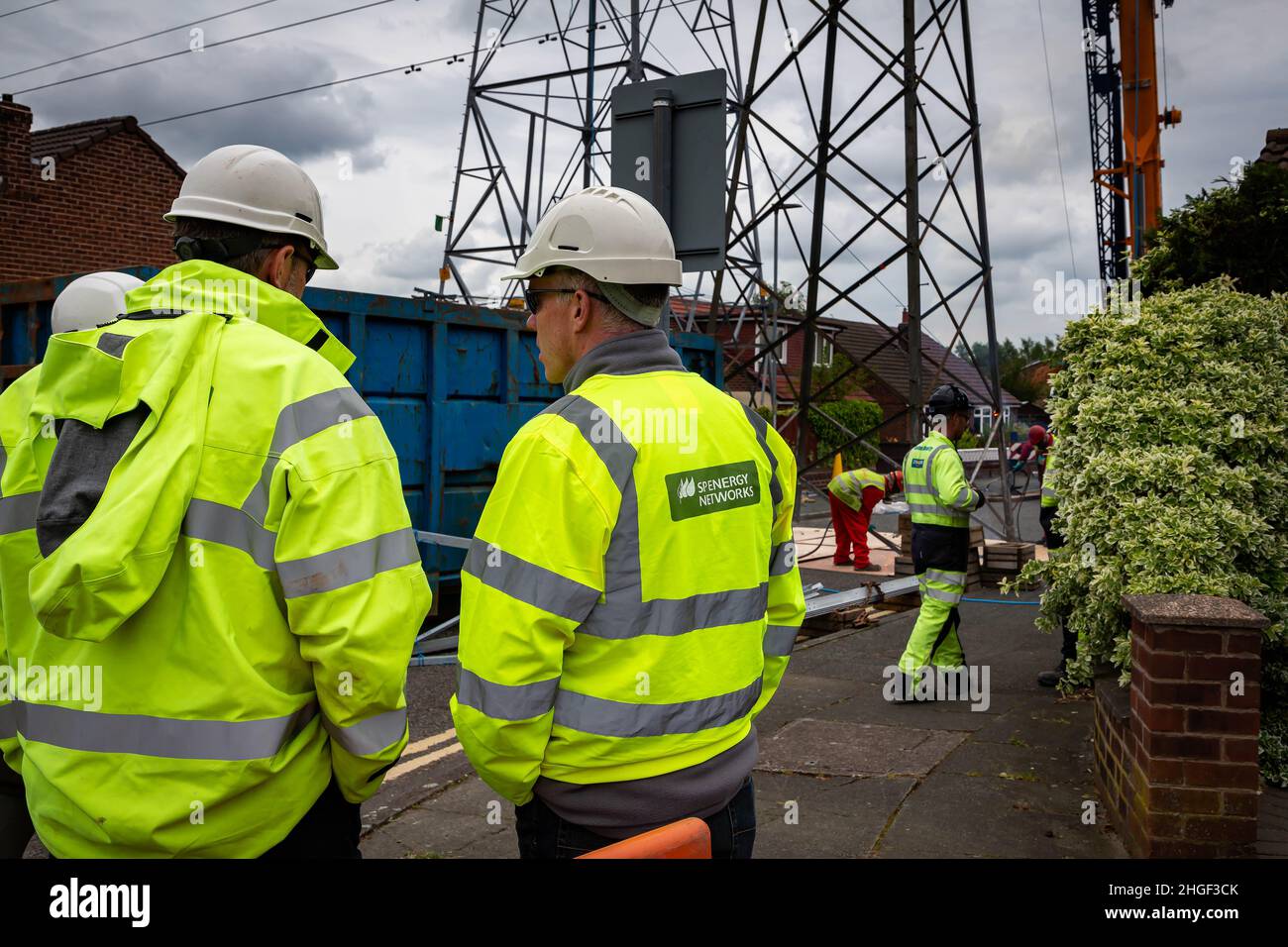 Workmen in PPE use oxy acetylene torches to cut out damaged parts of a ...