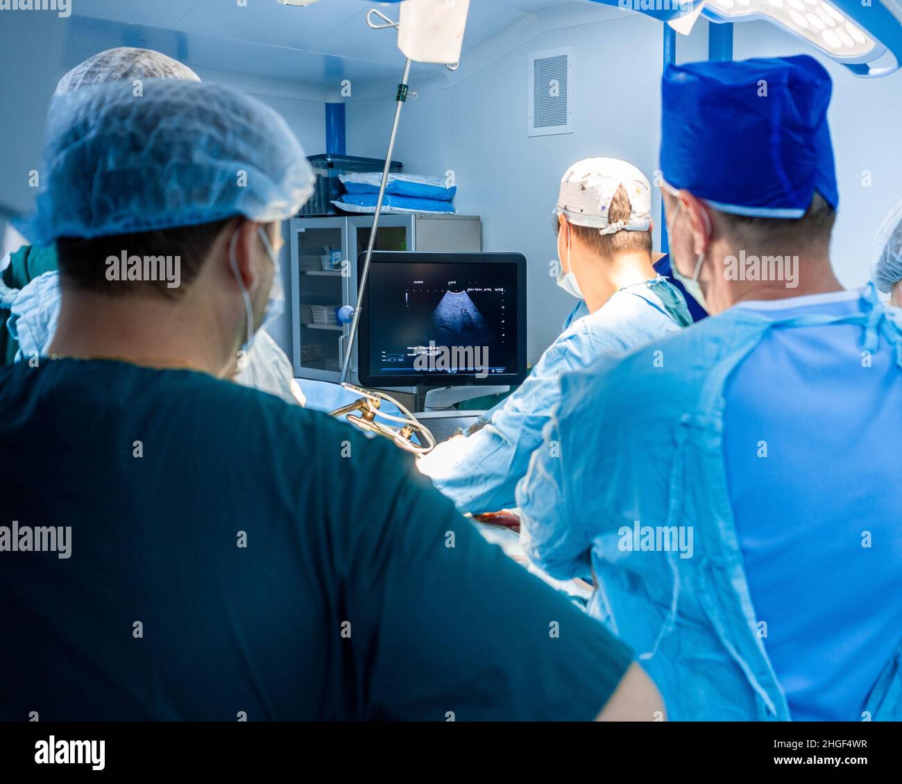 Surgeons monitor the condition of the patient's internal organs during ...