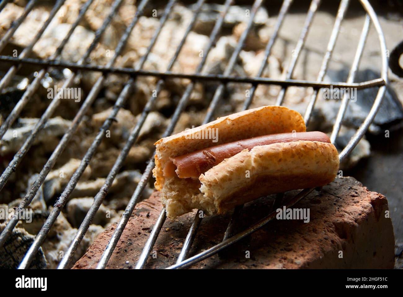 Barbecue sausage with sausage bread outdoors on the grill trellis Stock ...