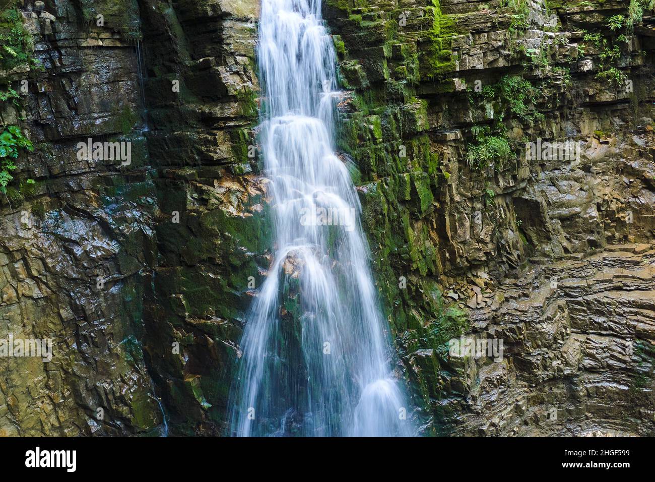 Waterfall on mountain river with white foamy water falling down from ...