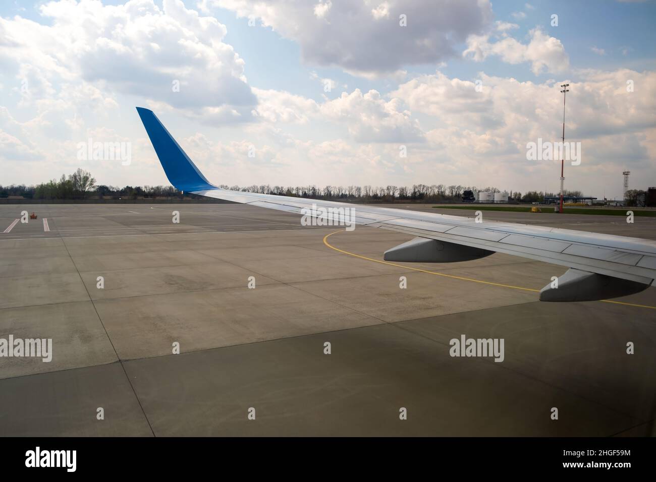 View of jet airplane wing taxiing runway after landing at airport ...