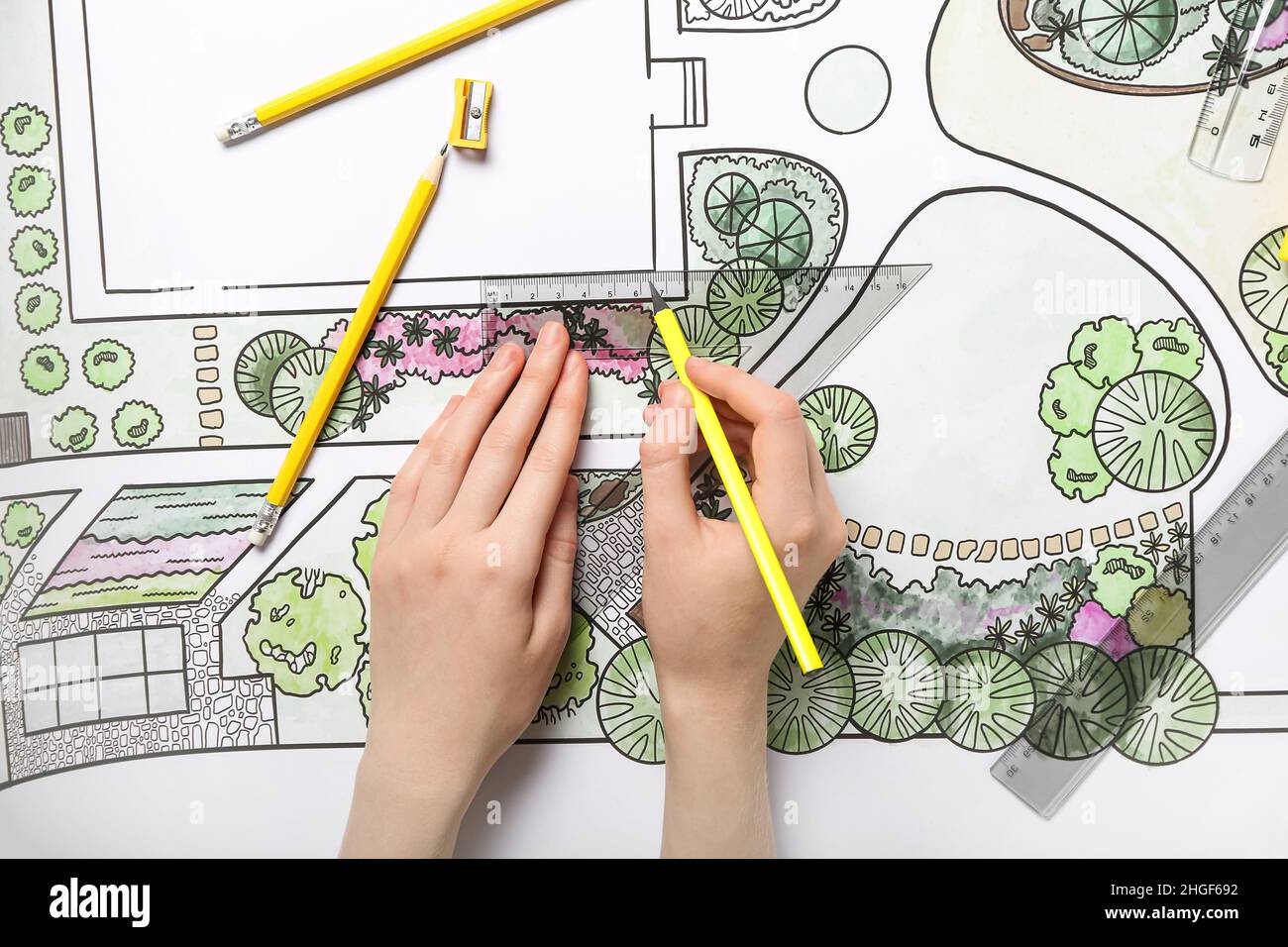 Landscape designer drawing on plan of garden Stock Photo - Alamy