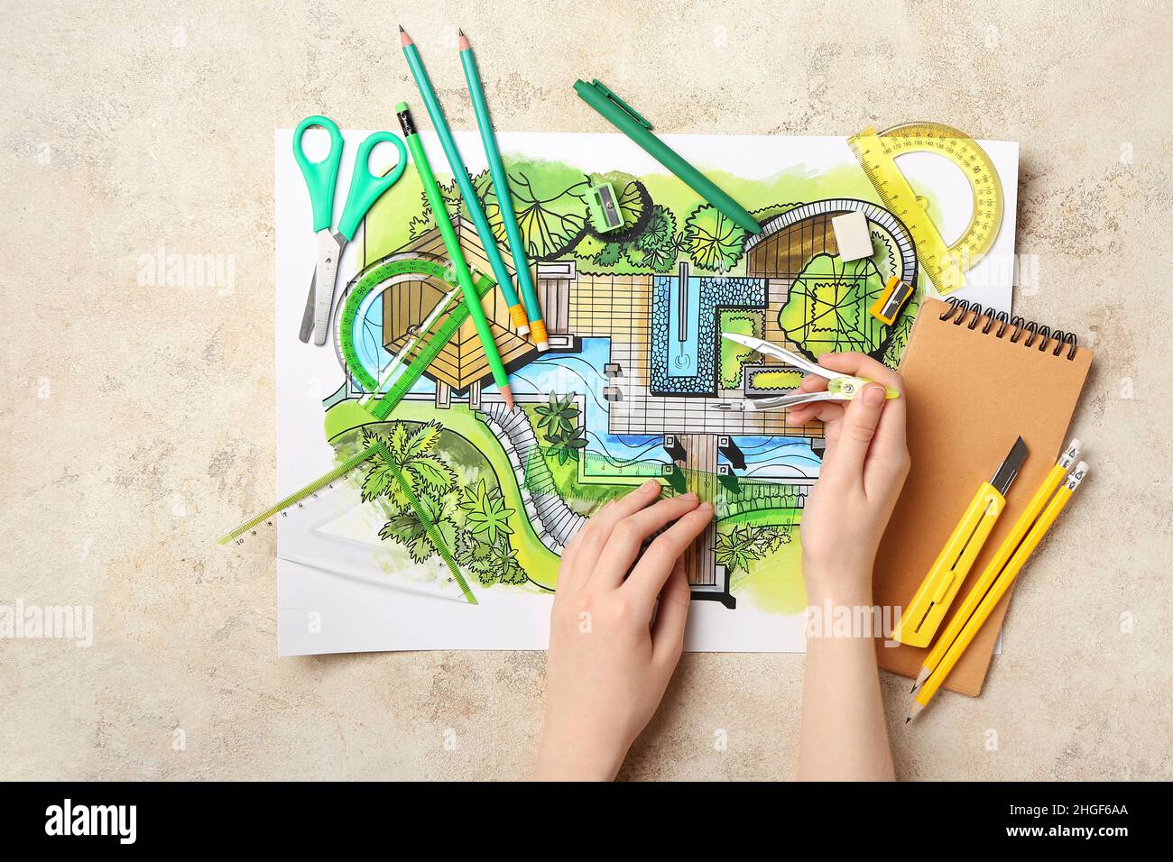 Landscape designer with pair of compasses and plan on grunge background ...