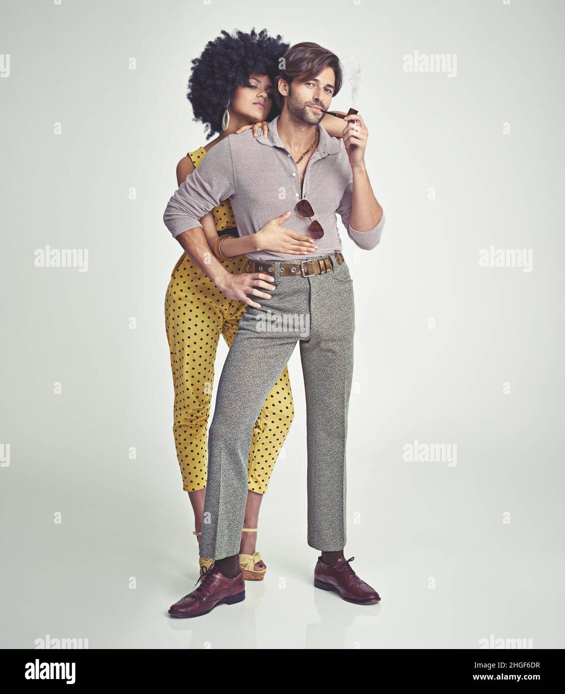 Retro couple. An attractive young couple standing together in retro 70s ...