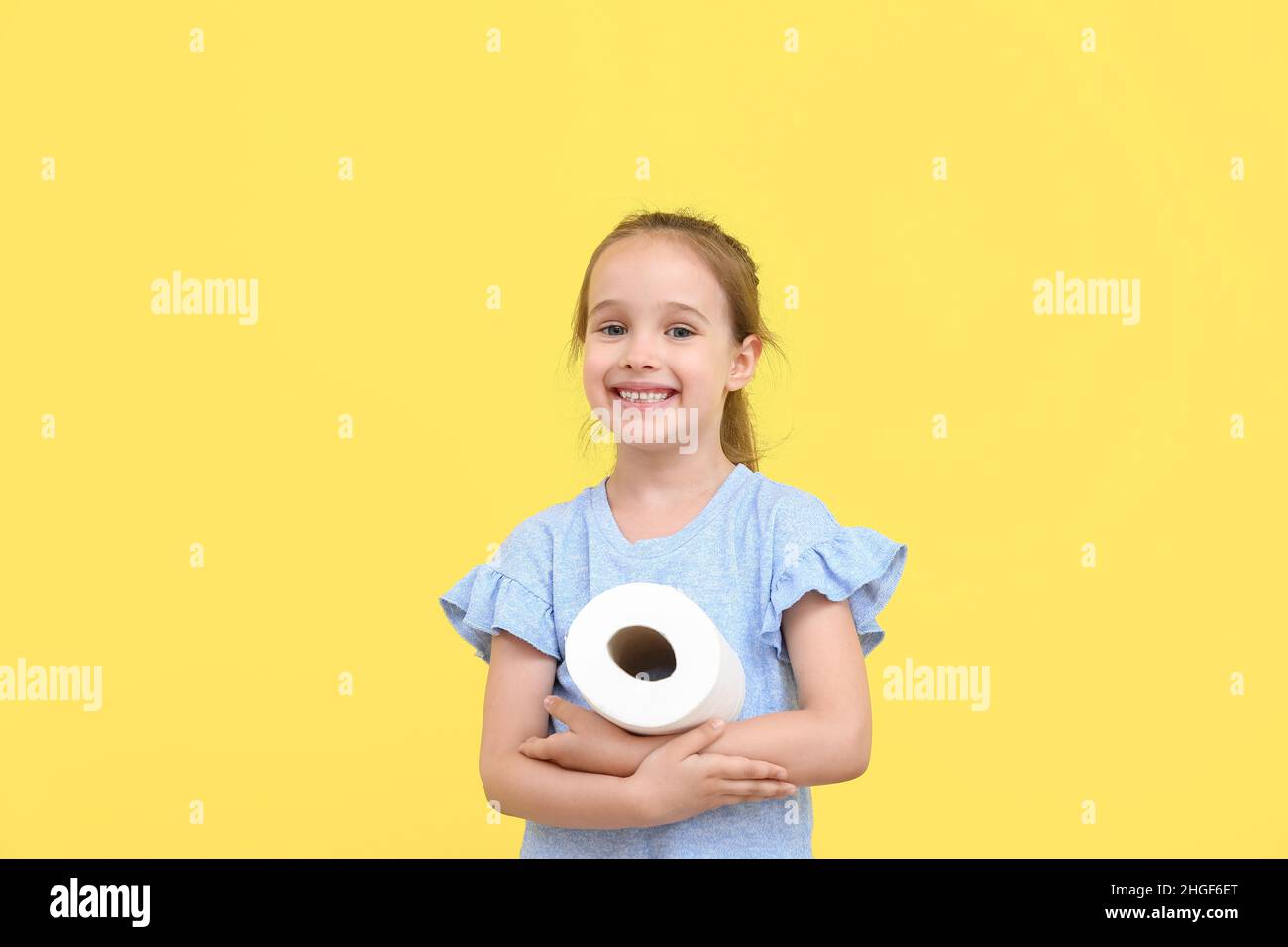 Funny little girl with toilet paper on yellow background Stock Photo ...