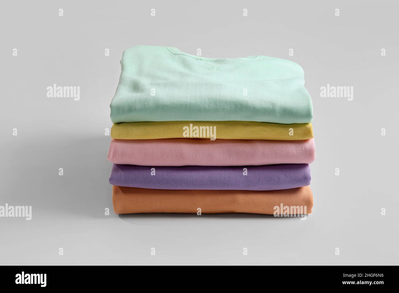 Stack of colorful clothes on white background Stock Photo - Alamy