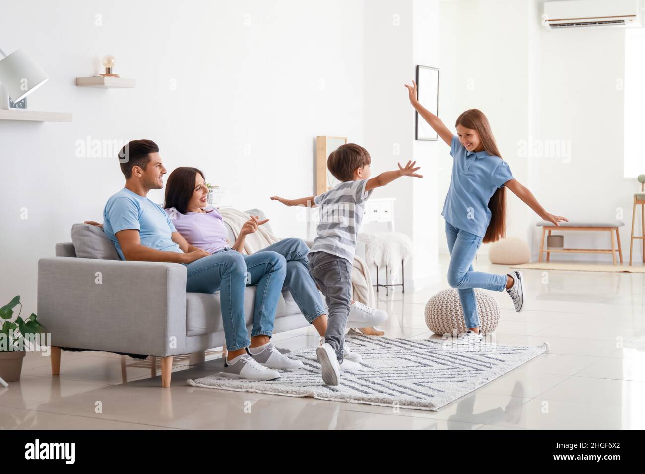 Happy parents and their dancing children at home Stock Photo - Alamy