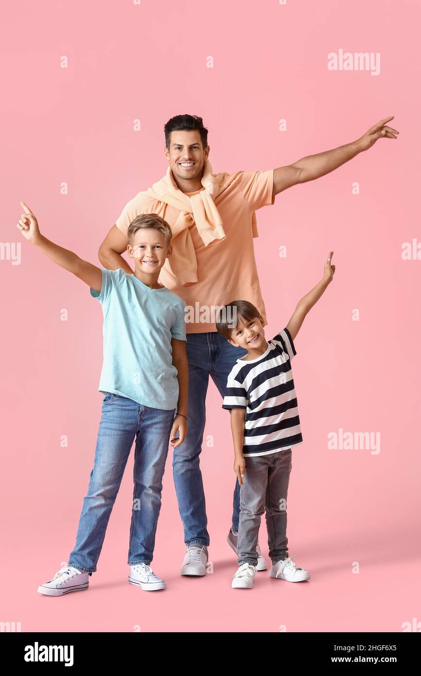 Happy man and his sons on color background Stock Photo - Alamy
