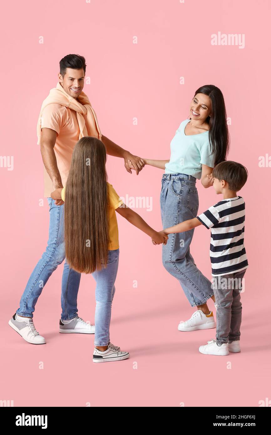 Happy dancing family on color background Stock Photo - Alamy