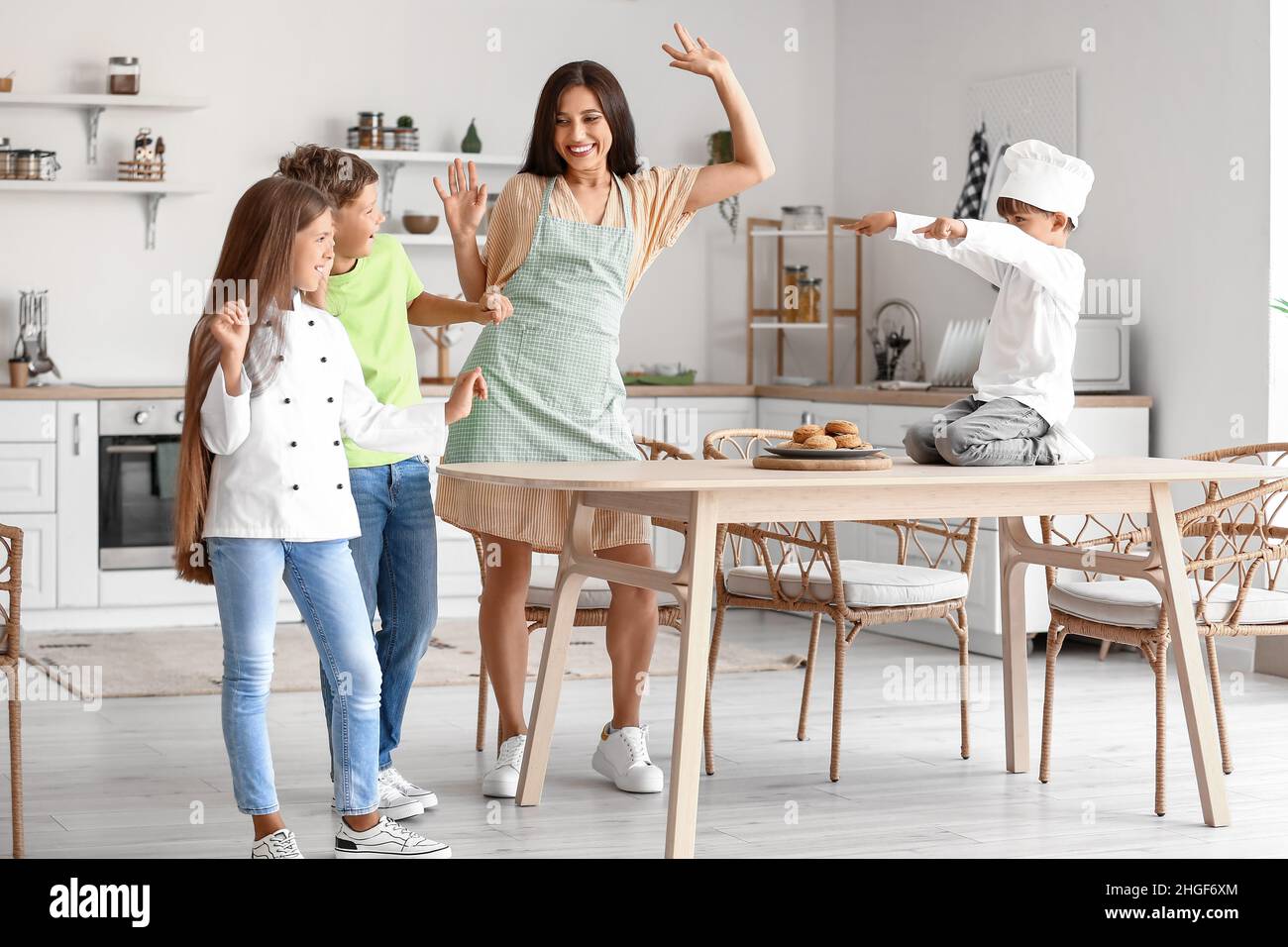Happy mother and her children dancing in kitchen Stock Photo - Alamy