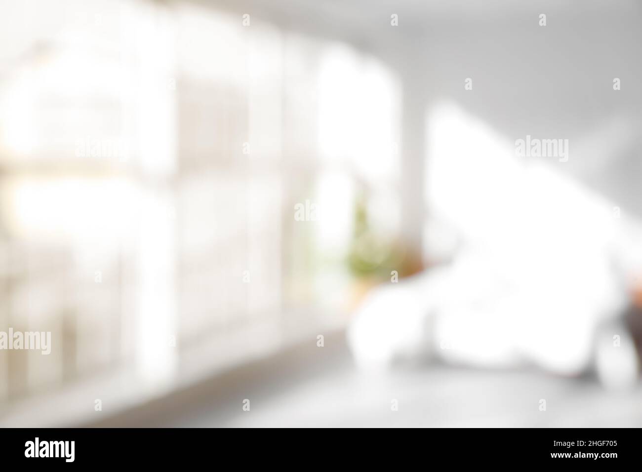 Blurred view of light bedroom with big window Stock Photo - Alamy