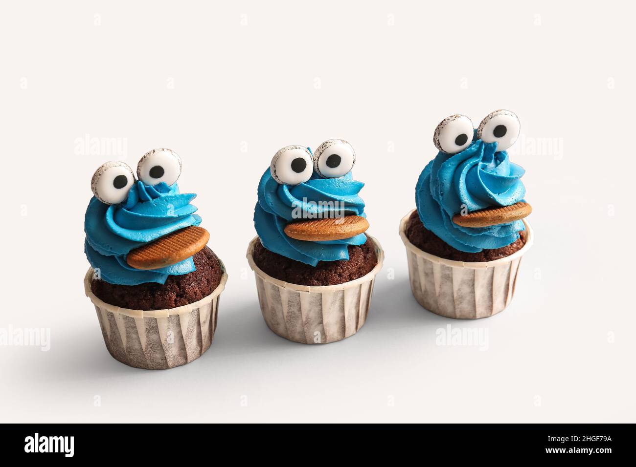 Tasty funny cupcakes for Halloween celebration on white background ...