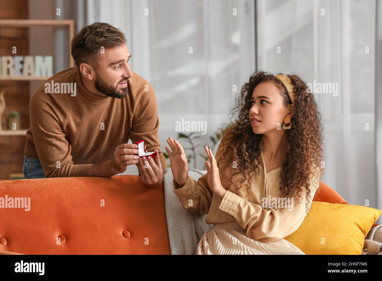 Young woman rejecting marriage proposal at home Stock Photo - Alamy