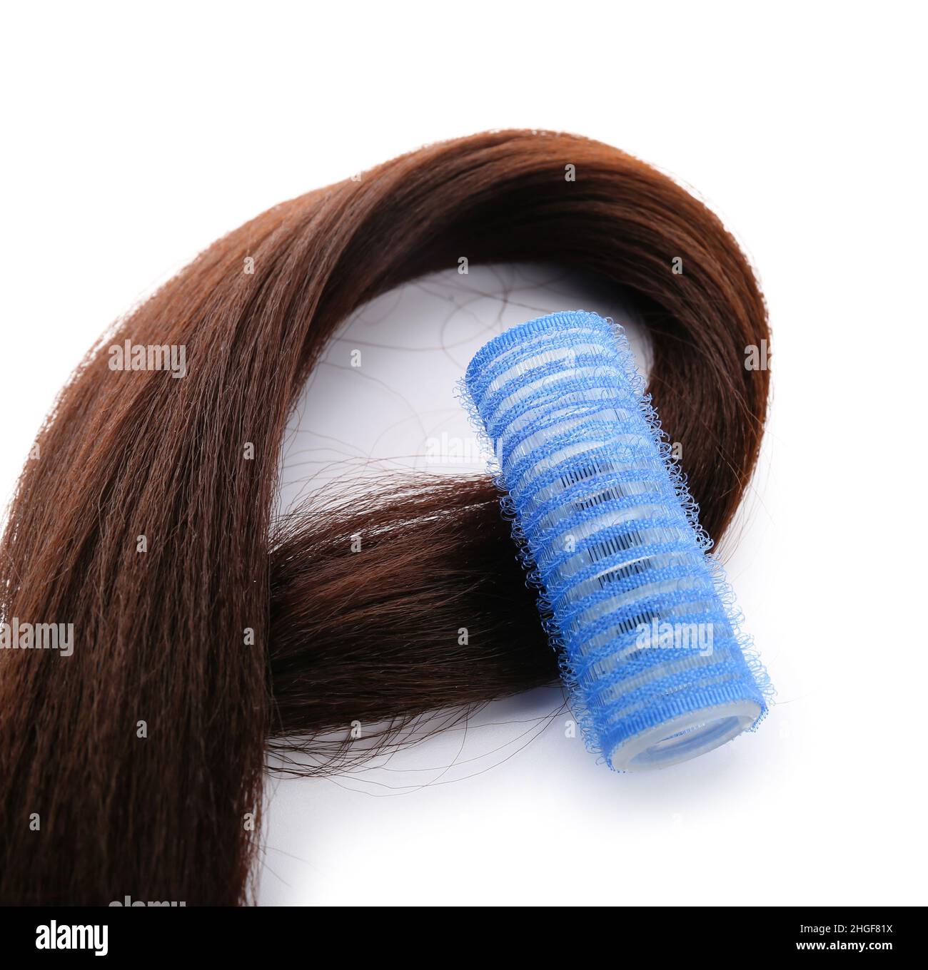 Long brunette hair with curler on light background, closeup Stock Photo - Alamy