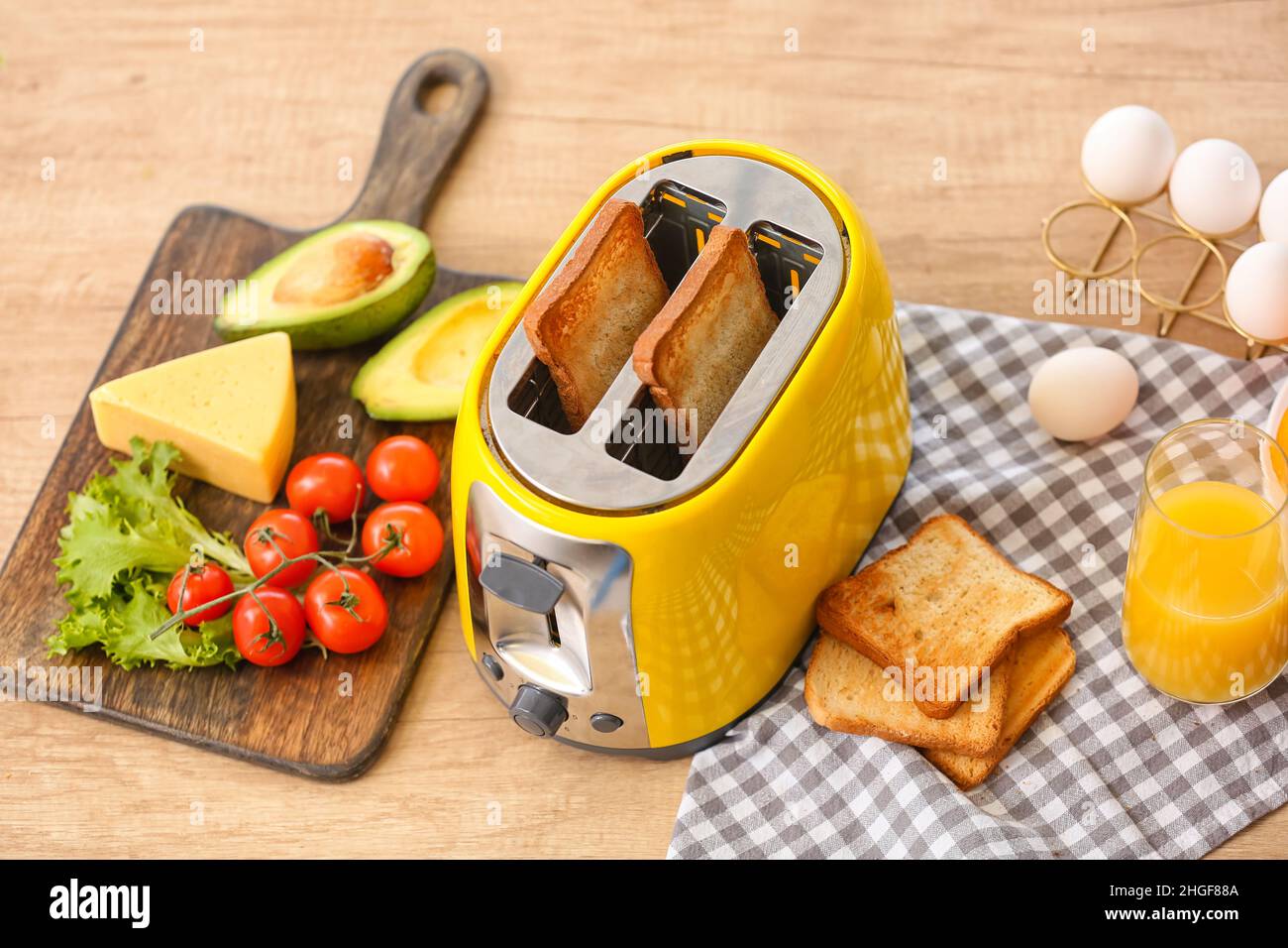Yellow toaster with healthy food on table in kitchen Stock Photo - Alamy