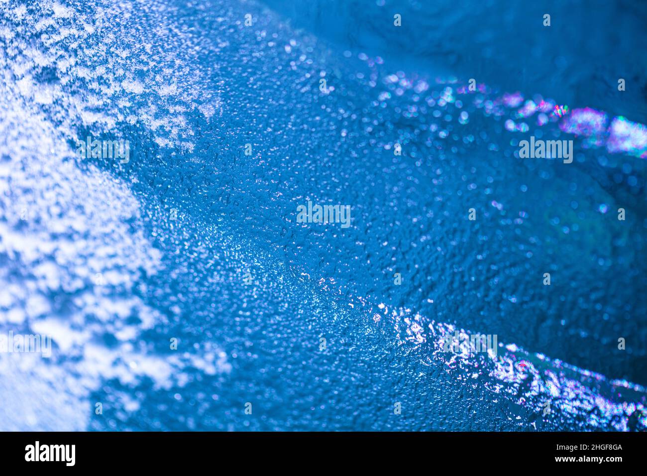 closeup of ice with colourful backlight for design purpose, textured ...