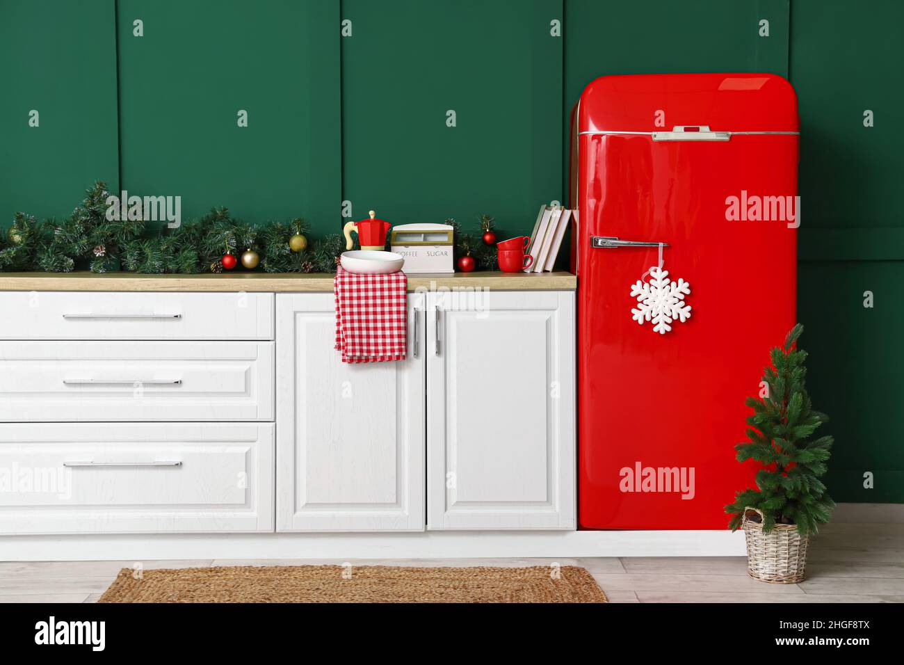 Red fridge with small Christmas tree in kitchen decorated for holiday ...